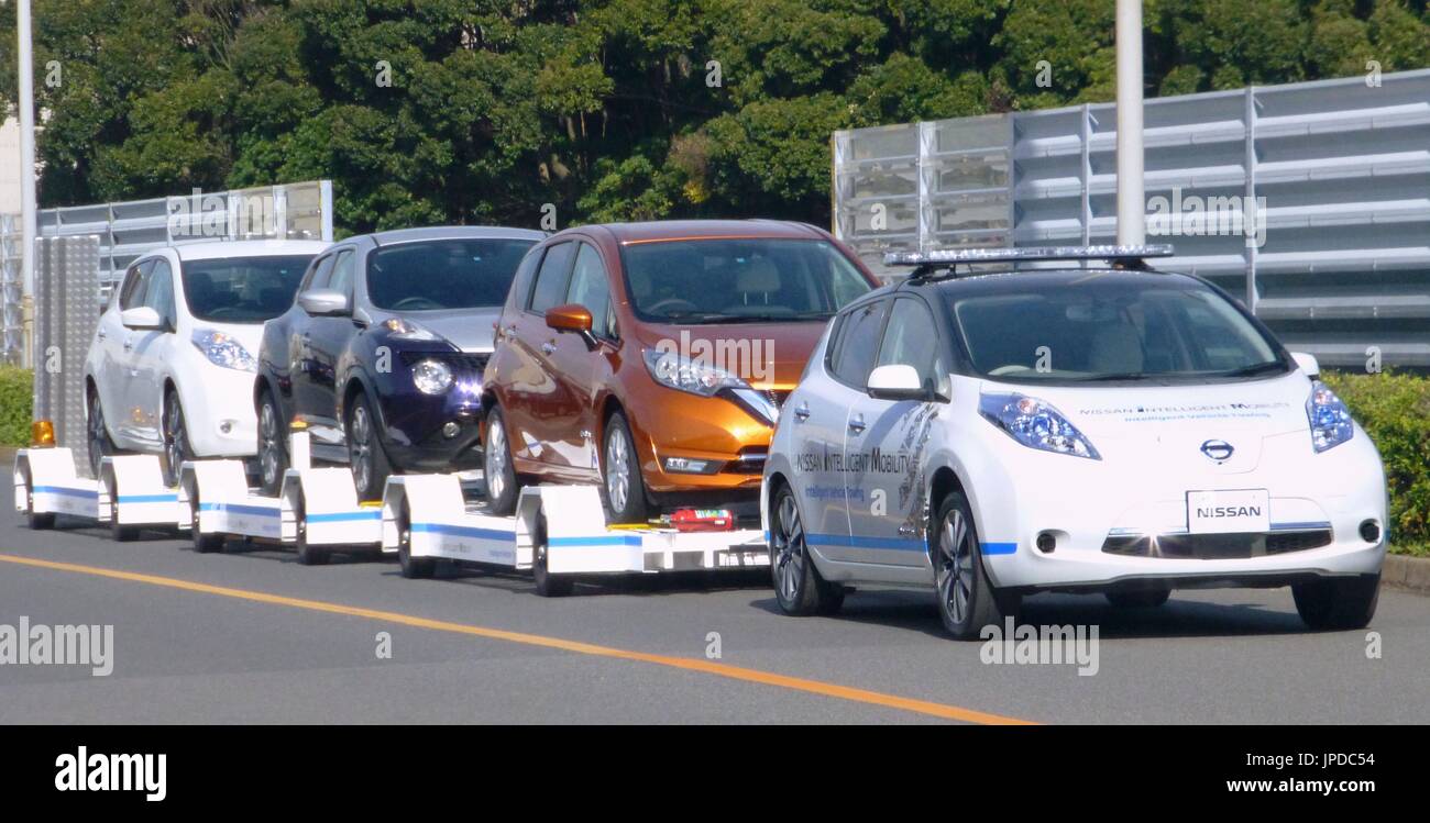 A self-driving car (front) tows finished cars to a shipping port at a ...