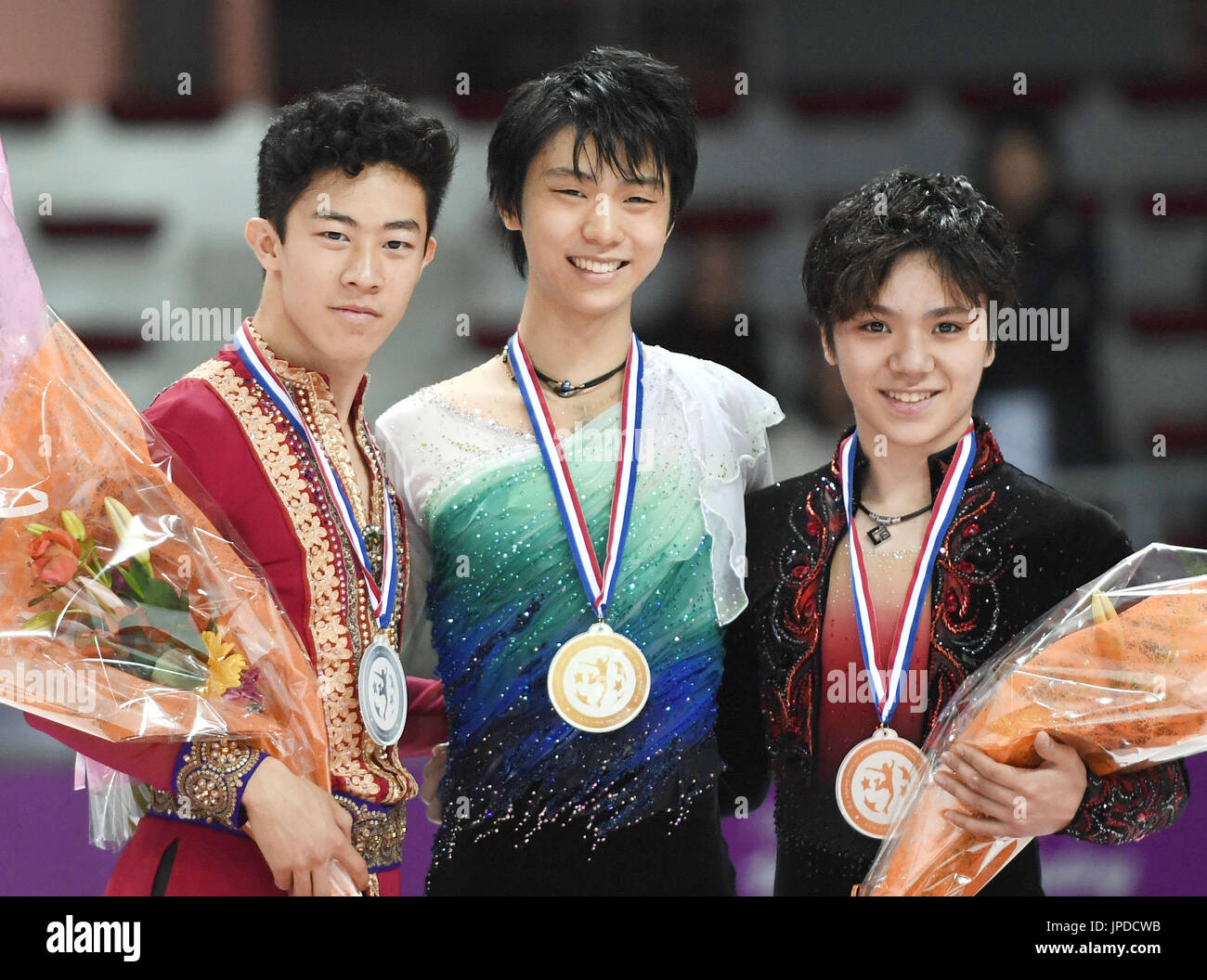 Japan's Yuzuru Hanyu (C) smiles during the victory ceremony after ...