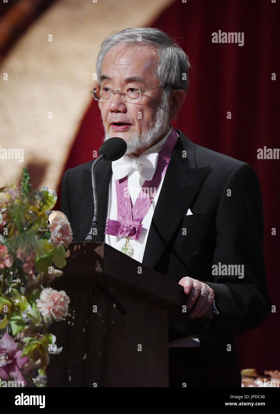 Nobel laureate Yoshinori Ohsumi gives a speech during a banquet ...