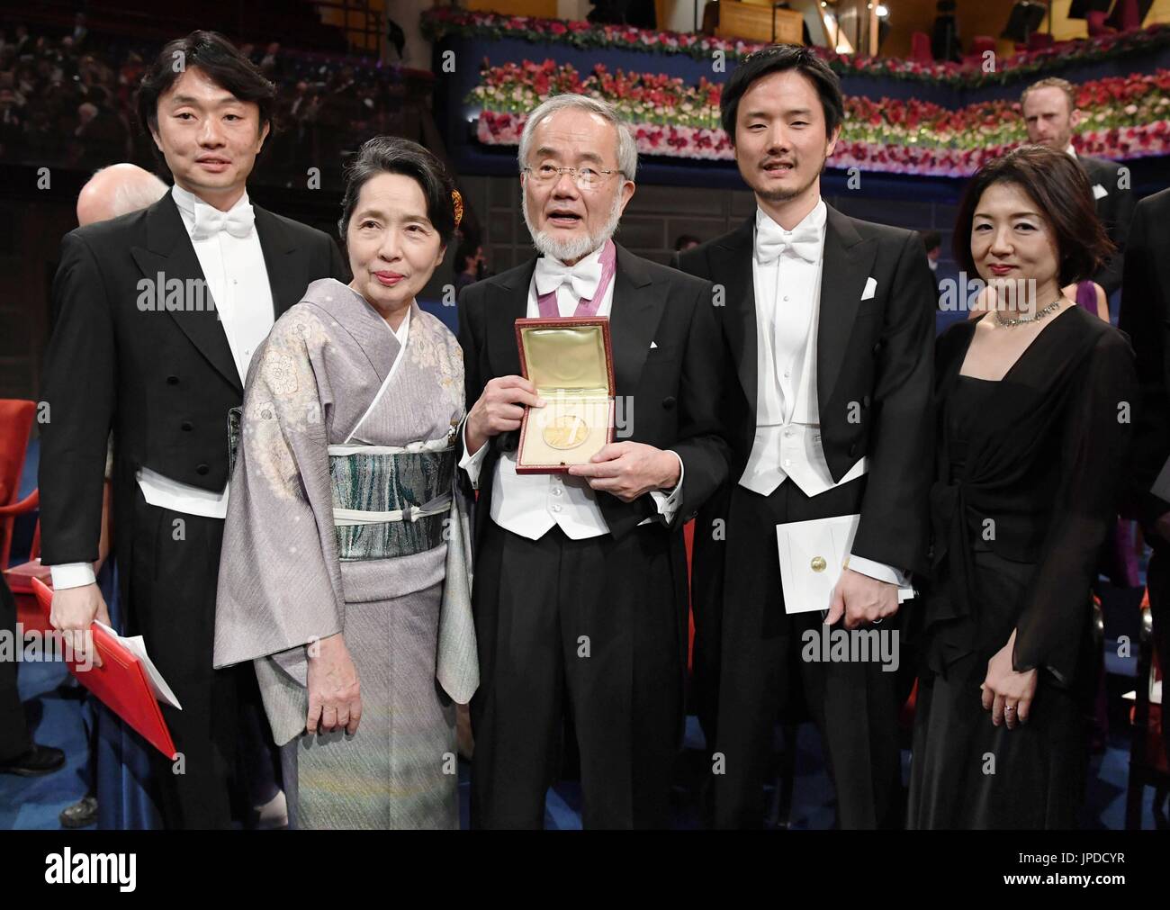Nobel laureate Yoshinori Ohsumi (C) poses for photos, together with his ...