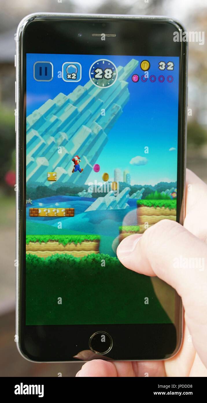 A smartphone displays "Super Mario Run," a side-scrolling adventure ...