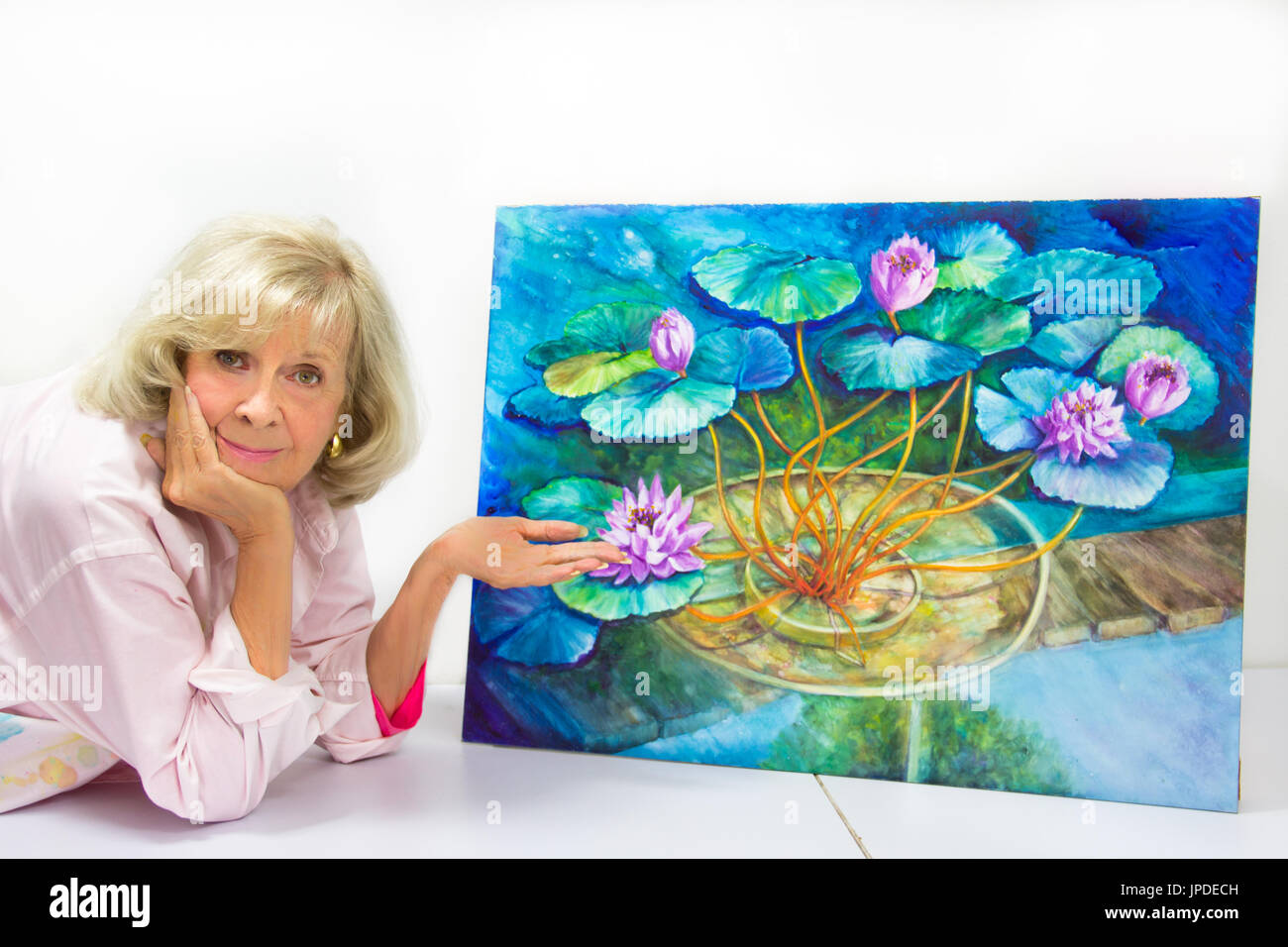 An artist is showing her finished painting Stock Photo - Alamy