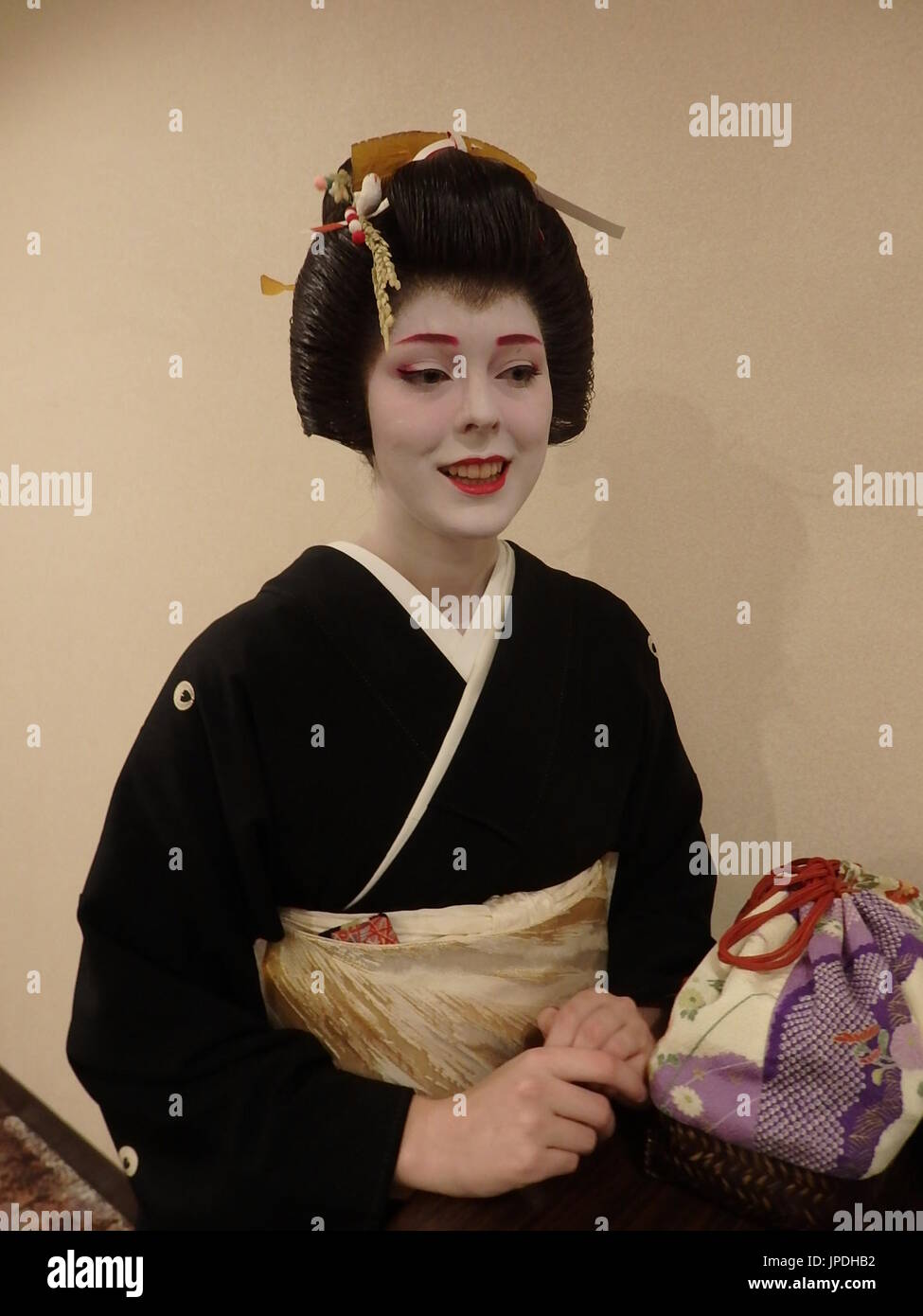 Dressed in kimono and wearing traditional Japanese hairstyle for women ...