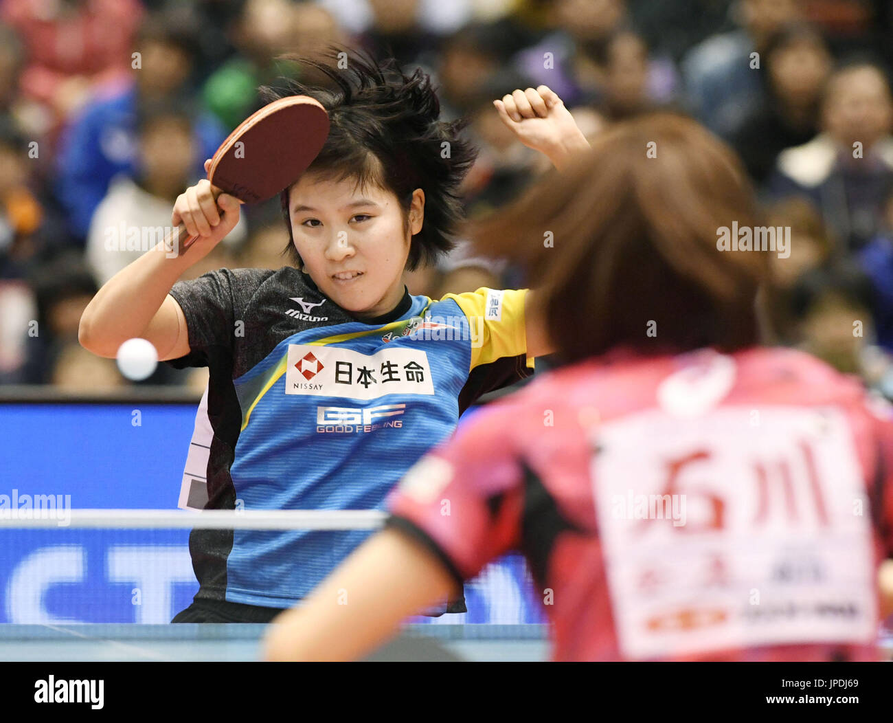 Miu Hirano (back) plays against Kasumi Ishikawa in the women's singles ...
