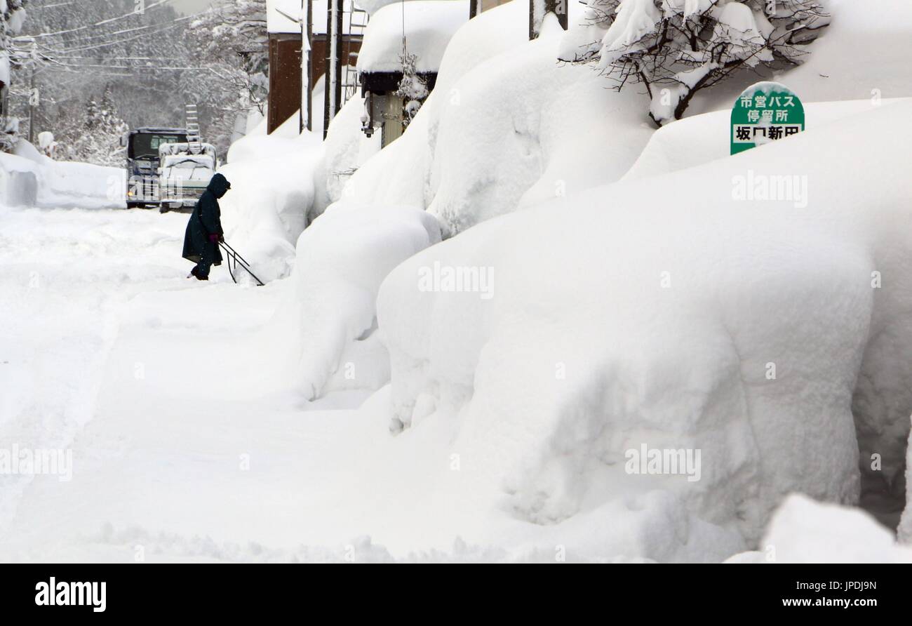 A bus stop is buried deep in snow, with only its top visible (front R ...