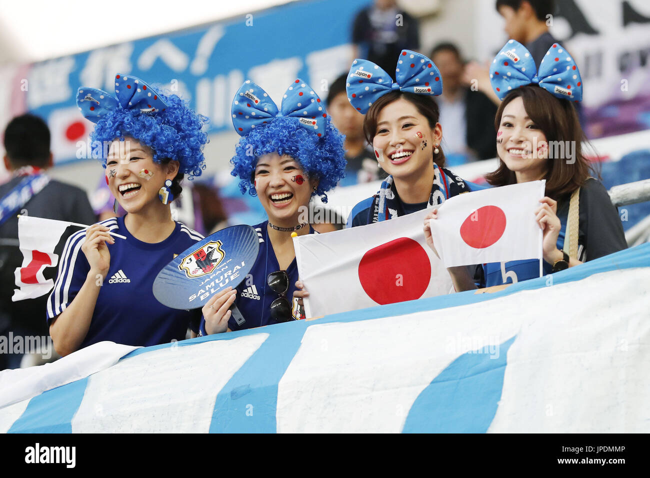 Supporters of the Japanese soccer team smile in the stands prior to a ...