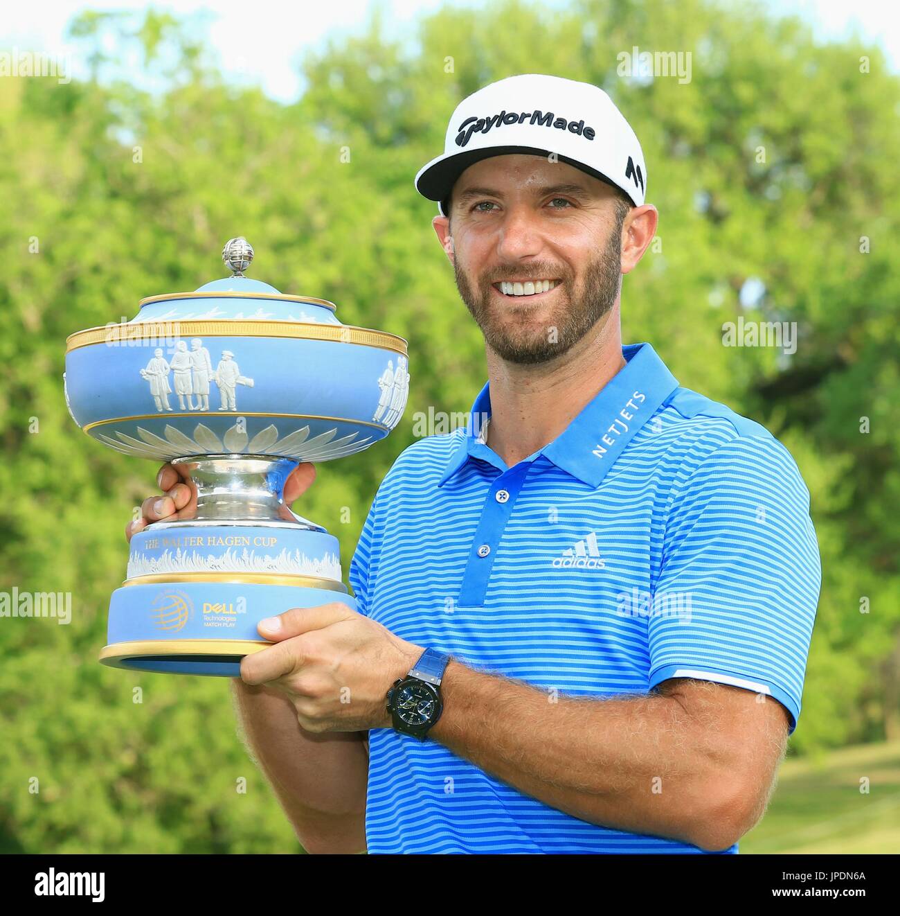 Dustin Johnson of the United States poses with the winner's trophy ...