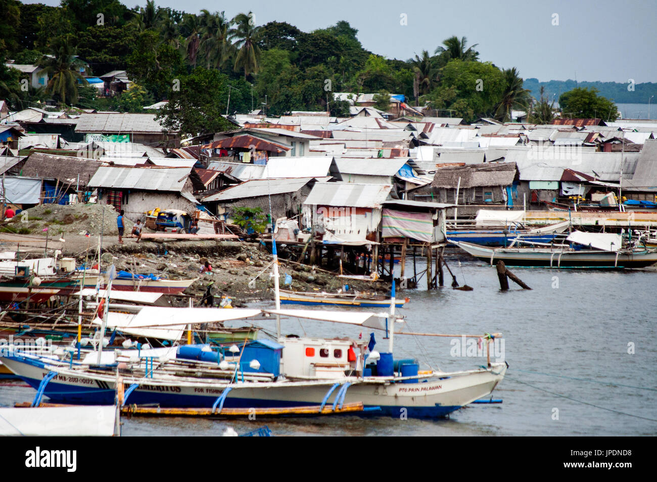 Aerial view of fishing boats and stilt fishing village near port ...