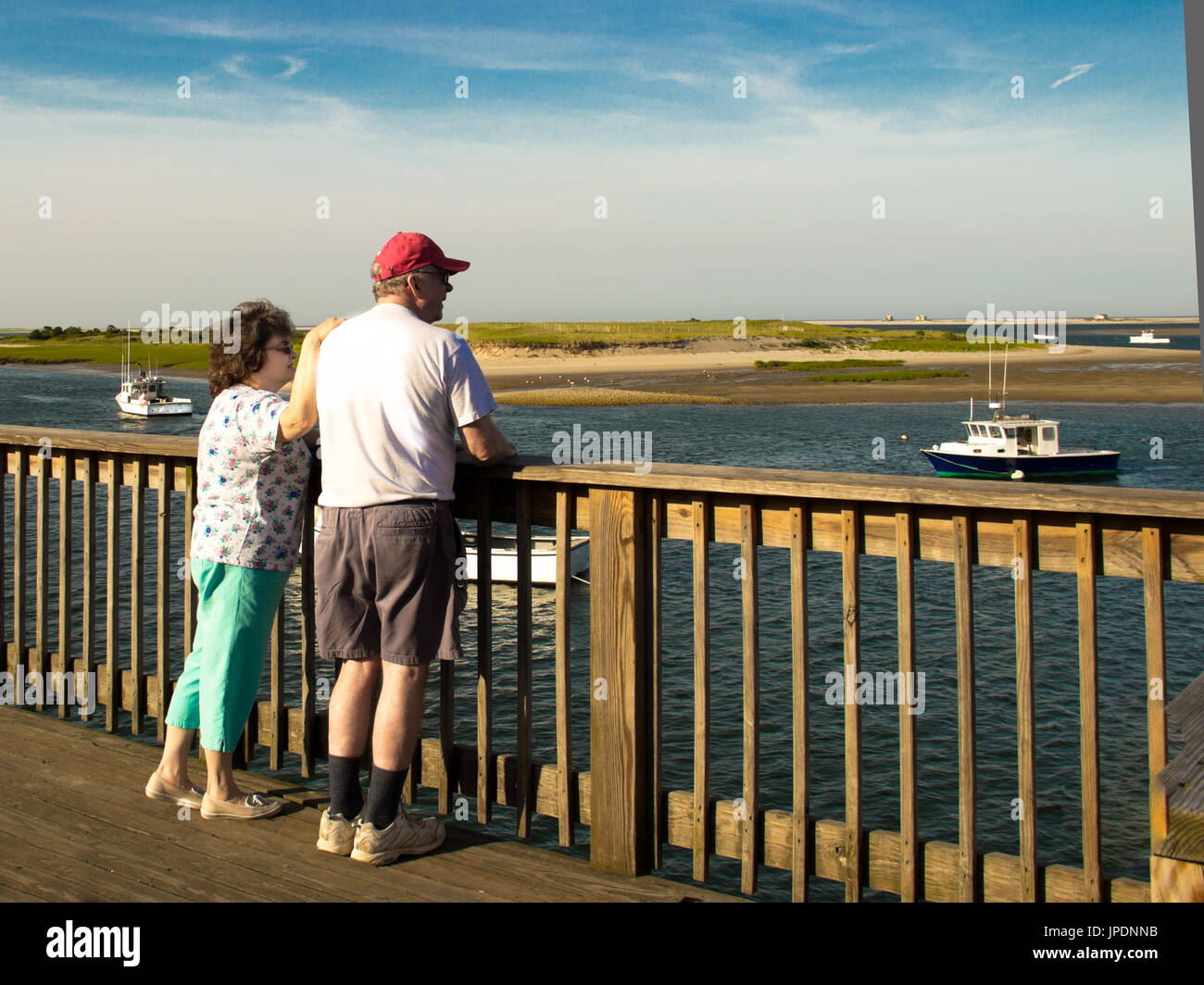 On a pier on Cape Cod, a woman and man are looking at the ocean Stock ...