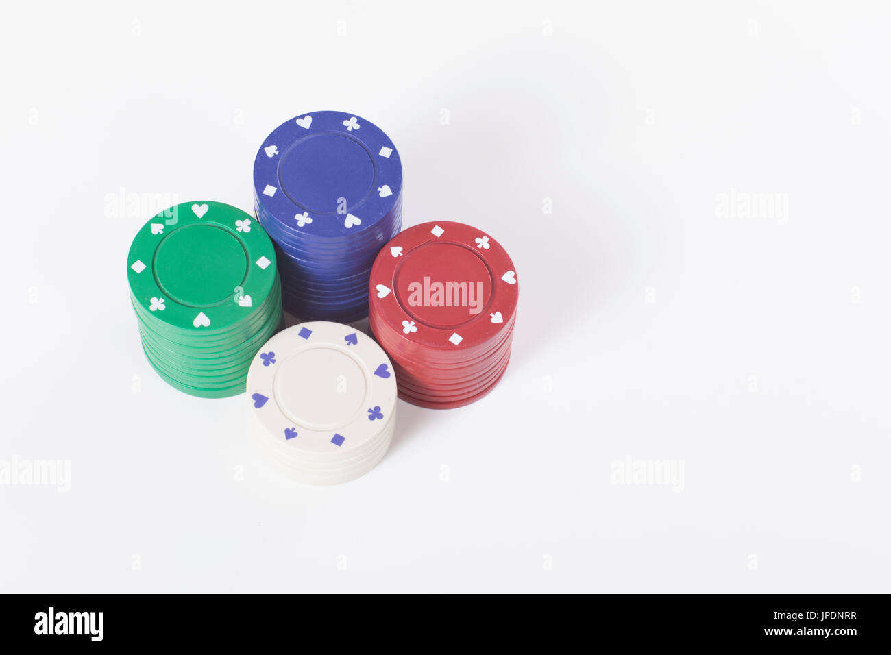 four stacks of different colored casino chips for placing bets on the ...