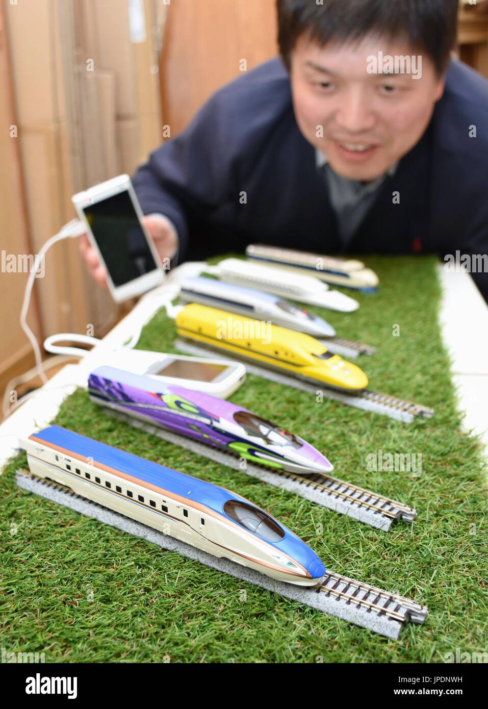 Masaru Yanai, president of Faith Inc., looks at shinkansen bullet train ...