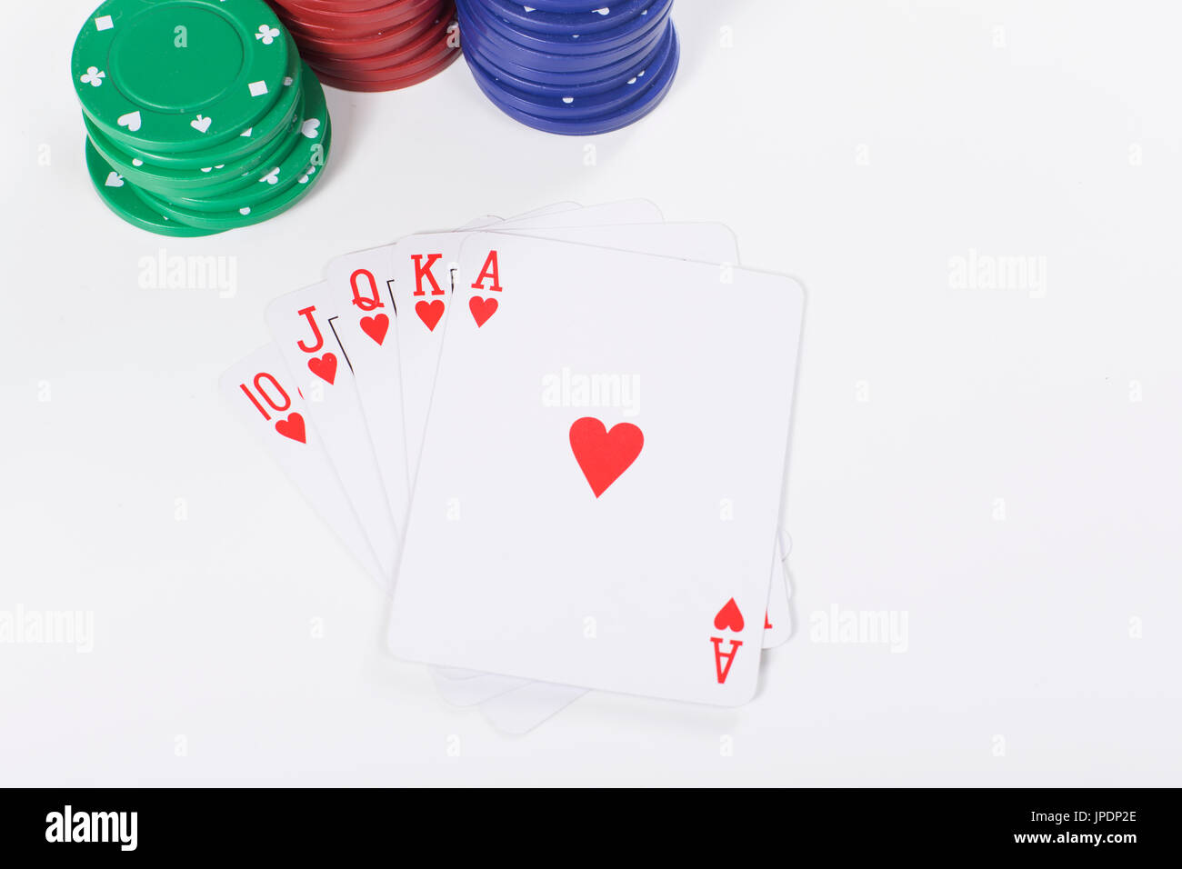 Three stacks of green, red and blue plastic poker chips placed below ...
