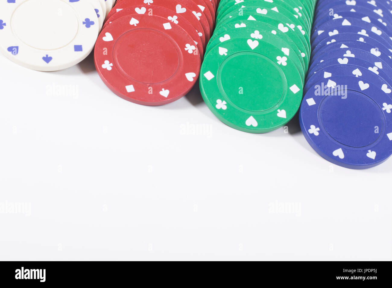 Angled close up on colorful poker chips over white background with copy ...