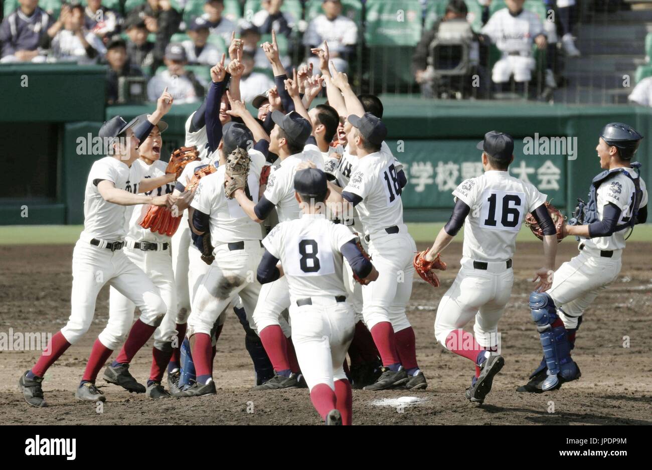 Players of Osaka Toin High School celebrate after scoring five nine ...