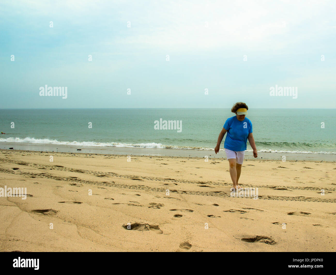 A woman gathers shells on Nauset Beach, MA, on Cape Cod Stock Photo - Alamy