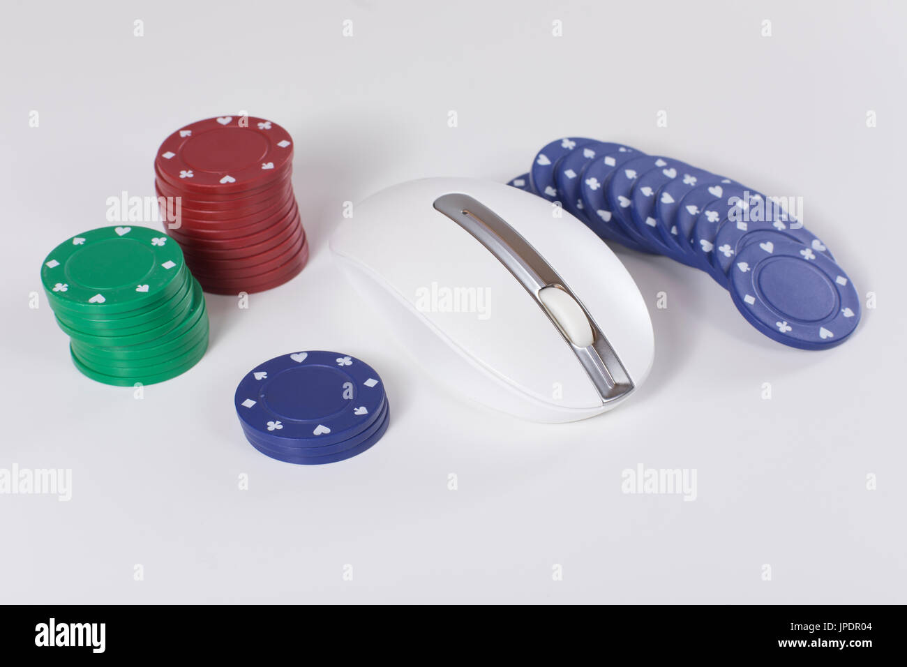 Single cordless computer mouse in the middle of white table with stacks ...