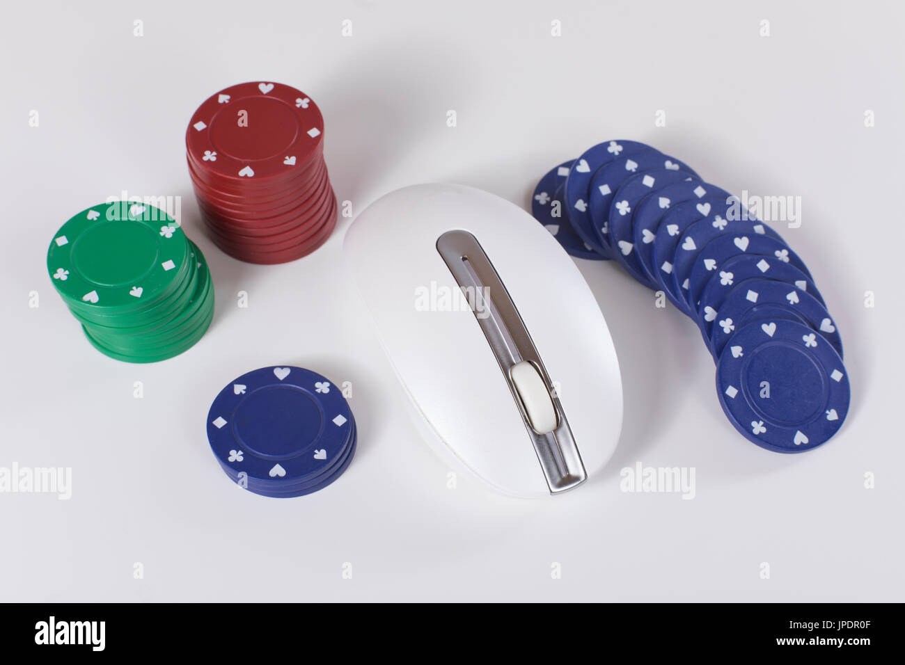 Cordless mouse controller in the middle of white table with stacks of ...