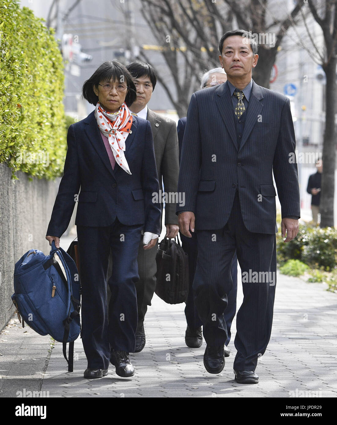 Koichi Fujiwara (R), chief of Osaka-based construction firm Fujiwara Kogyo, heads to the Osaka ...