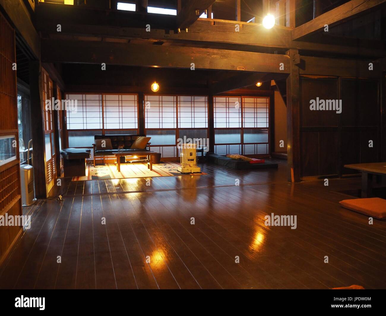 Photo shows the living room area of Kominka Yado LOOF, an old ...