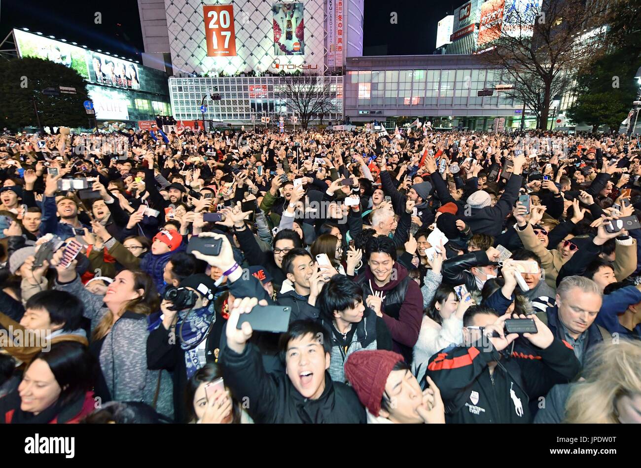 People cheer as they look up the New Year countdown clock and celebrate ...