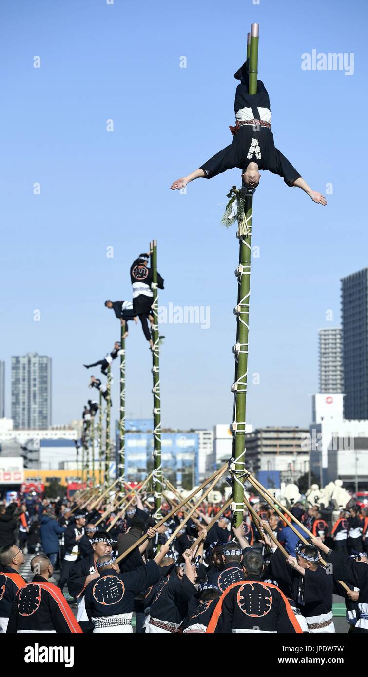 Firefighters perform the traditional ladder acrobatics during the ...