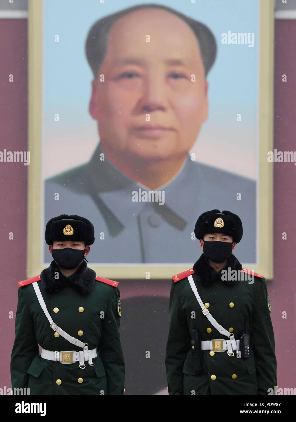 Riot police officers wearing masks stand guard at the Tiananmen gate in ...