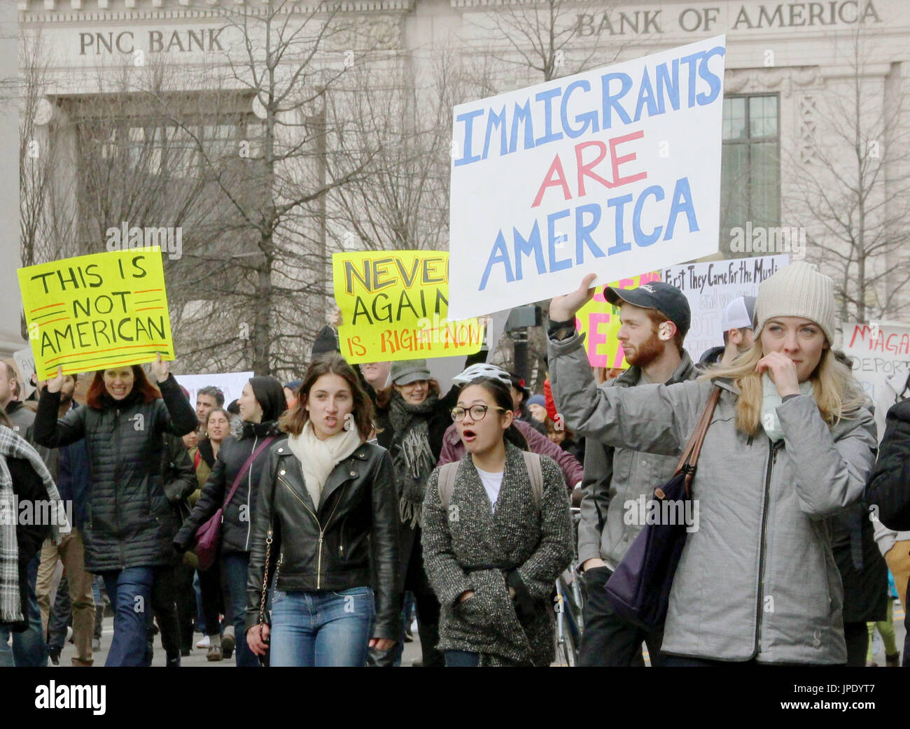 People holding placards march at a rally around the White House in ...