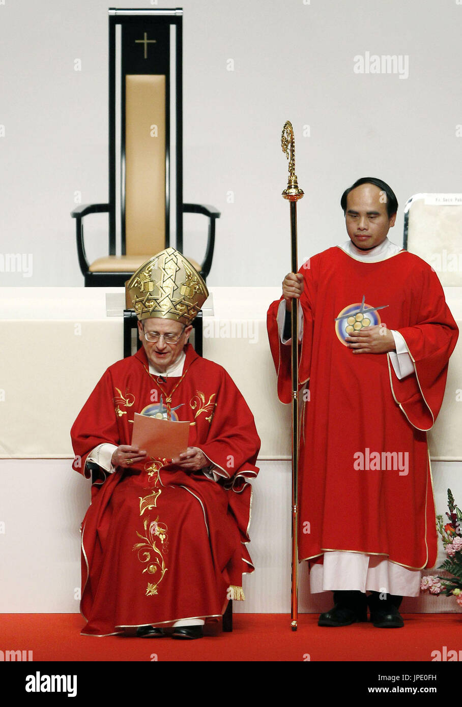 Cardinal Angelo Amato (L) reads out a letter from Pope Francis ...