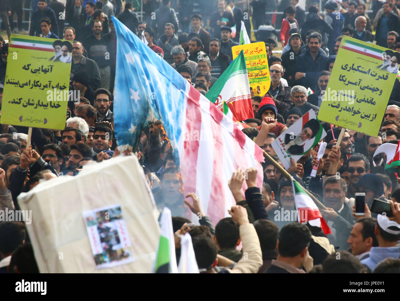 People set fire to the U.S. flag during a ceremony in Tehran to ...