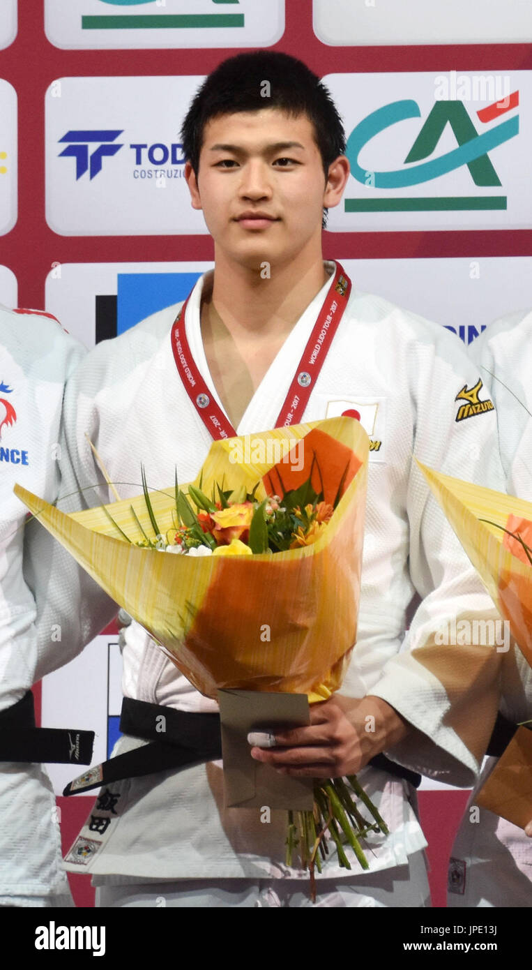 Japan's Kentaro Iida holds a bouquet after beating Cyrille Maret of ...
