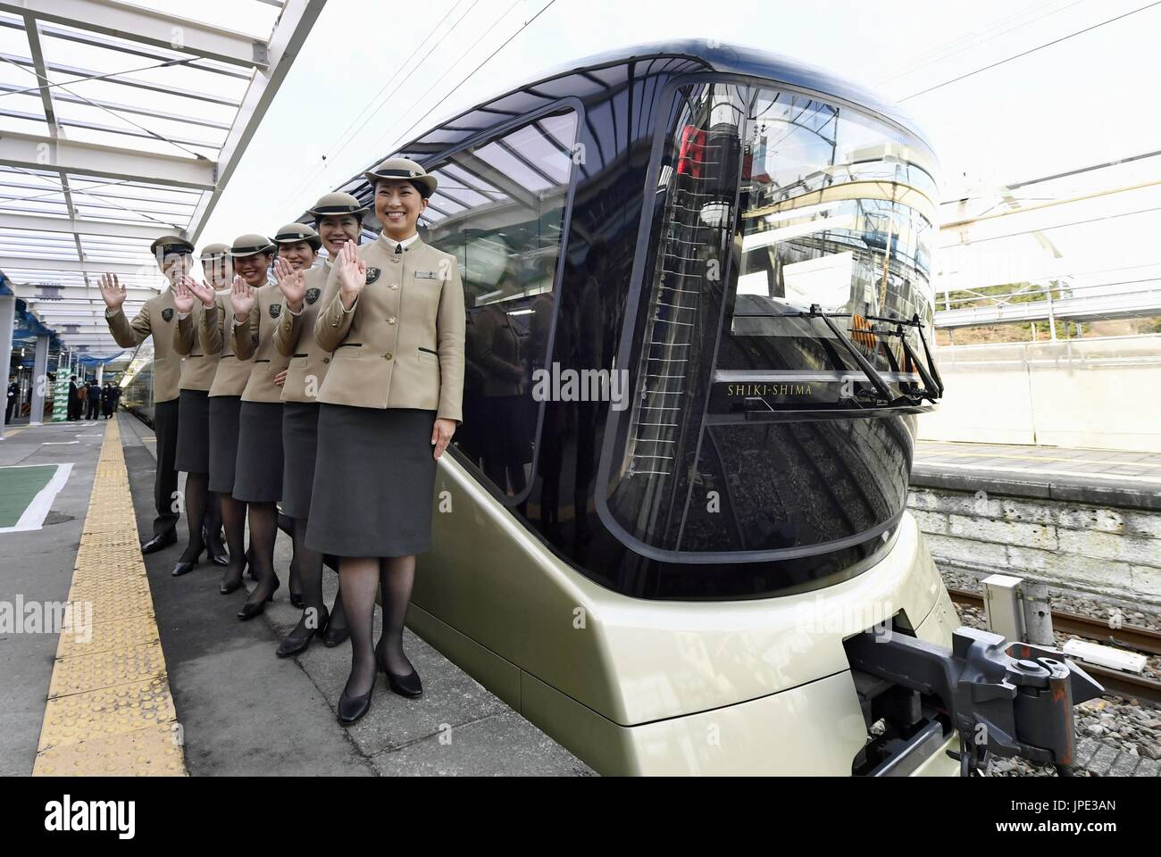 Crew members pose for a photo after East Japan Railway Co.'s Train ...