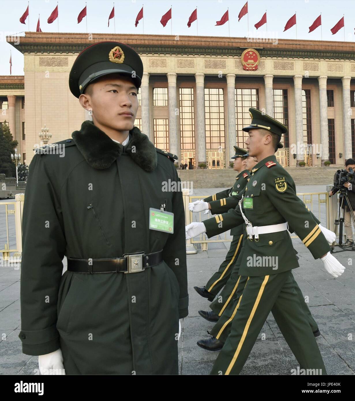 Security officials stand guard in front of the Great Hall of the People ...