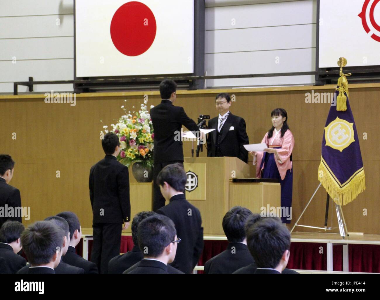A graduation ceremony is held at Kamaishi Higashi Junior High School on ...