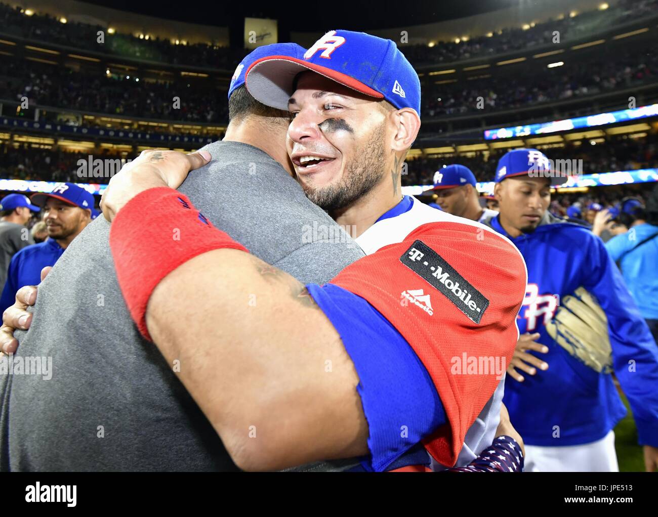 Puerto Rico team member Yadier Molina (R) embraces Giancarlo Stanton of ...