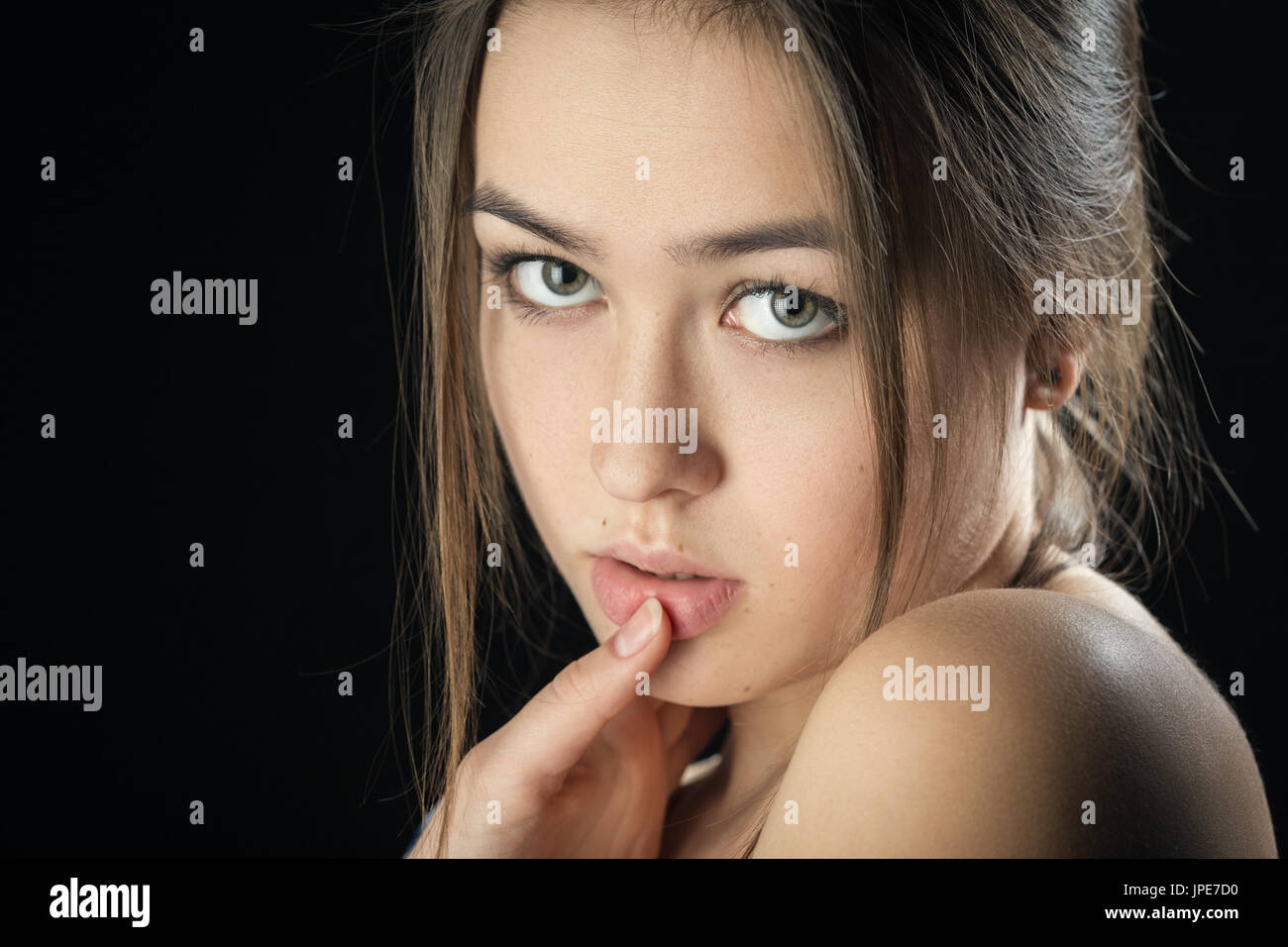 beautiful sad girl portrait on black background looking at camera Stock ...