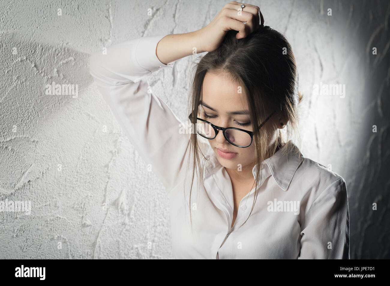 beautiful sad girl portrait near white wall Stock Photo - Alamy