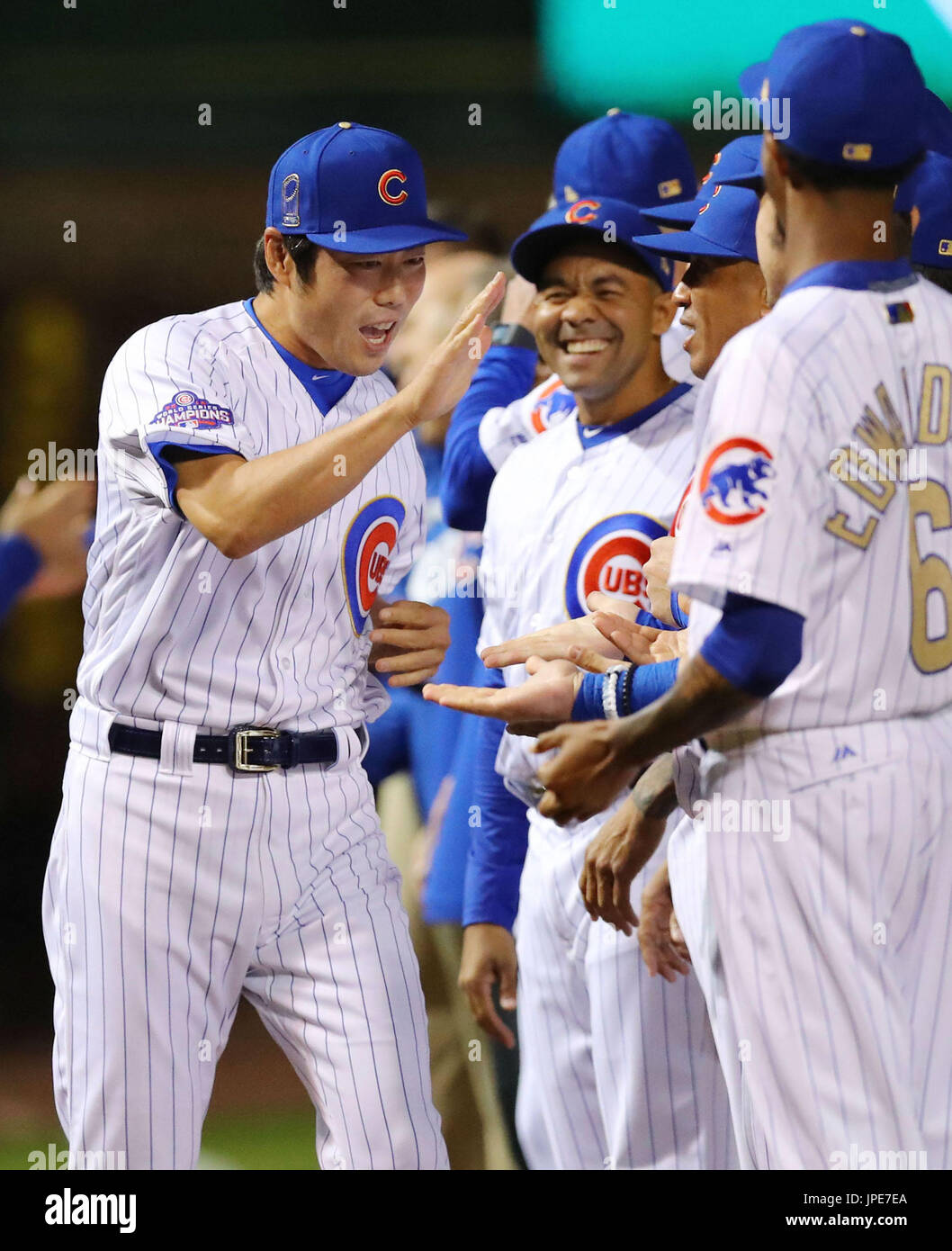 Chicago Cubs reliever Koji Uehara (far L) high fives teammates during ...