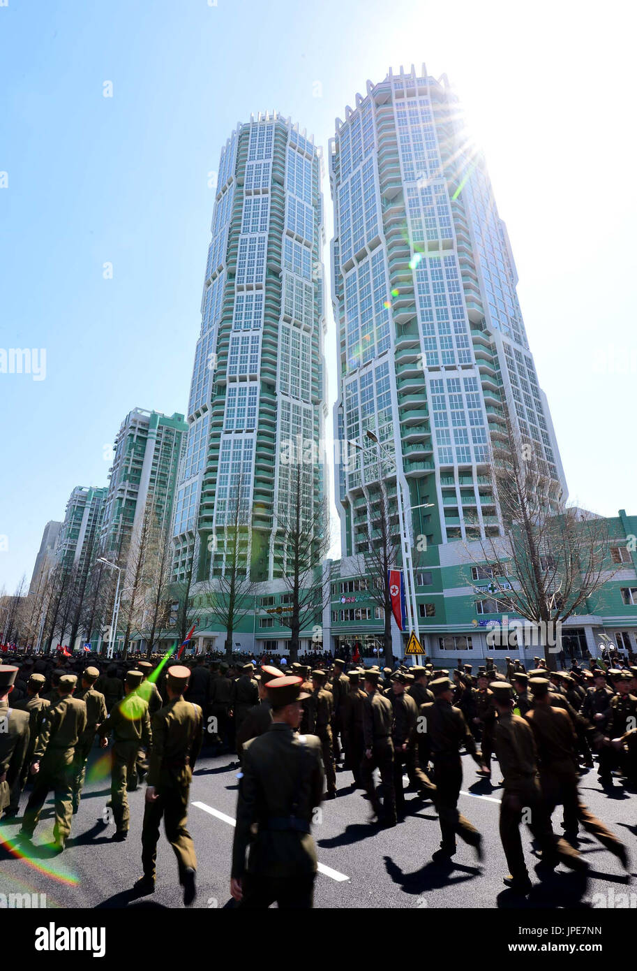 Military officers walk through a newly constructed residential area on ...