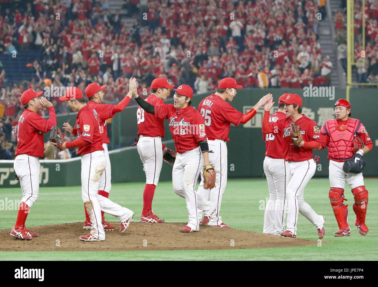 Players of the Hiroshima Carp celebrate after their 11-5 victory over ...