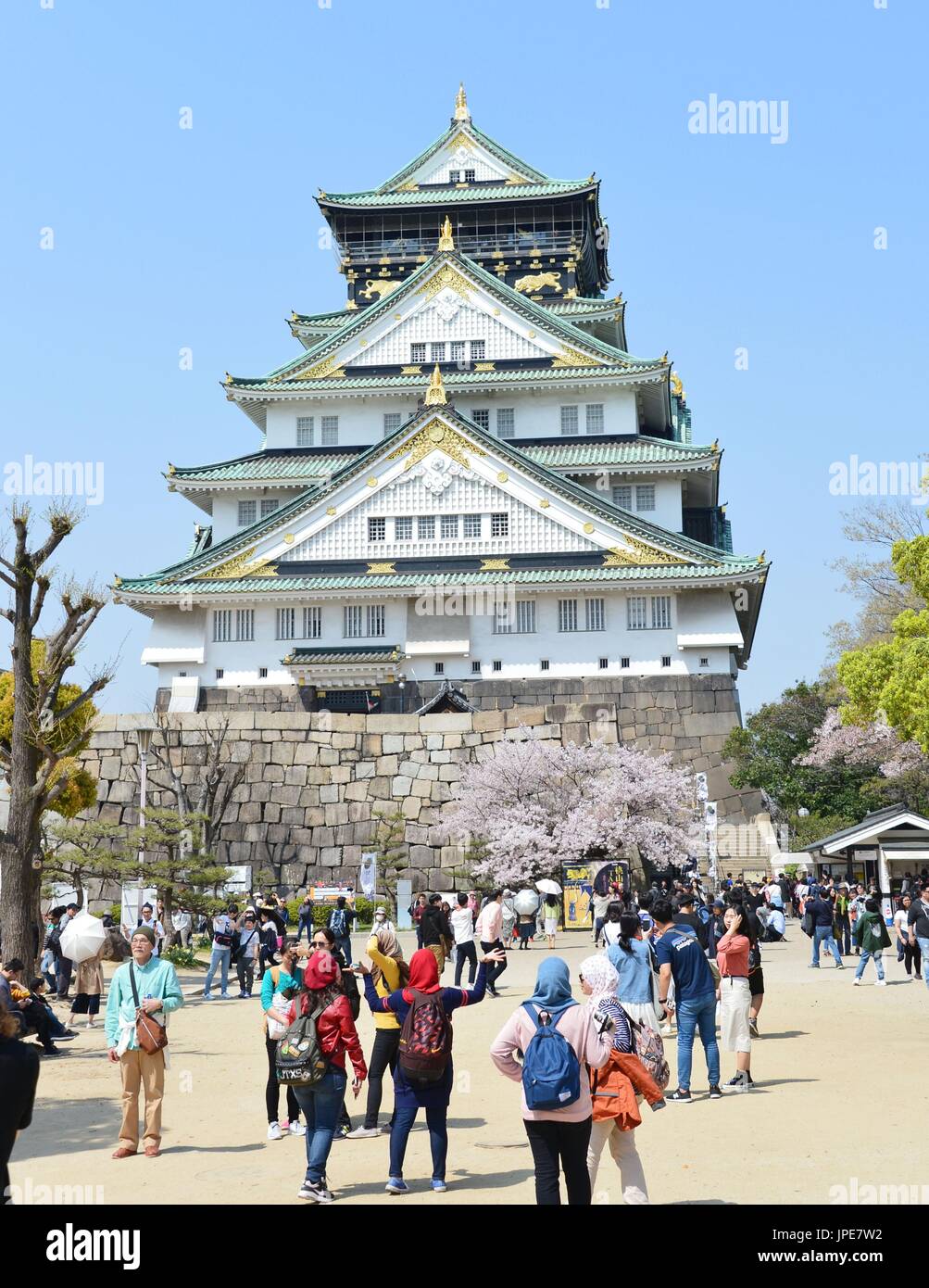 Tourists visit Osaka Castle in the western Japan city on April 14, 2017 ...