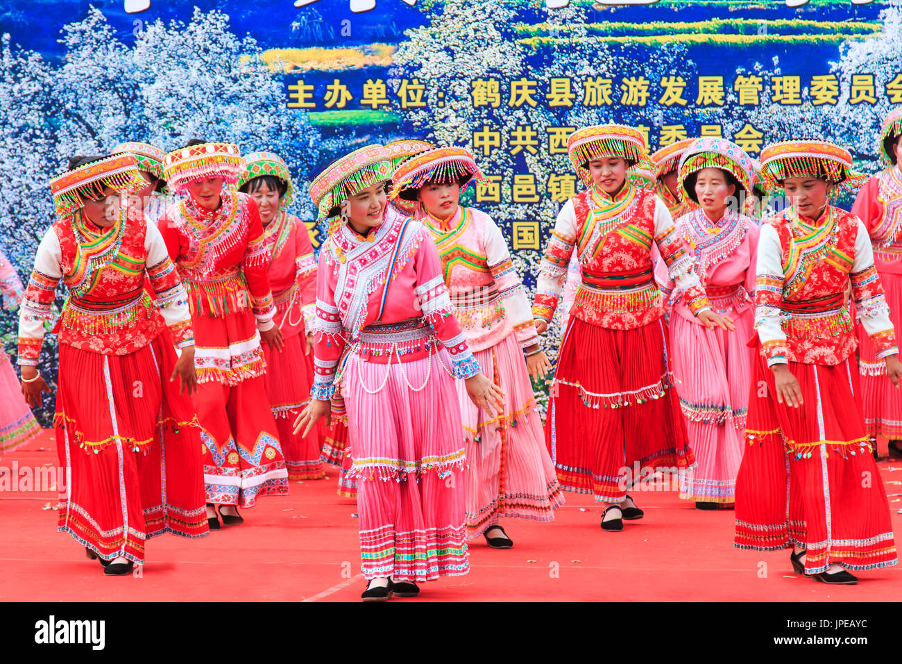 Chinese women dressed with traditional clothing dancing and singing ...