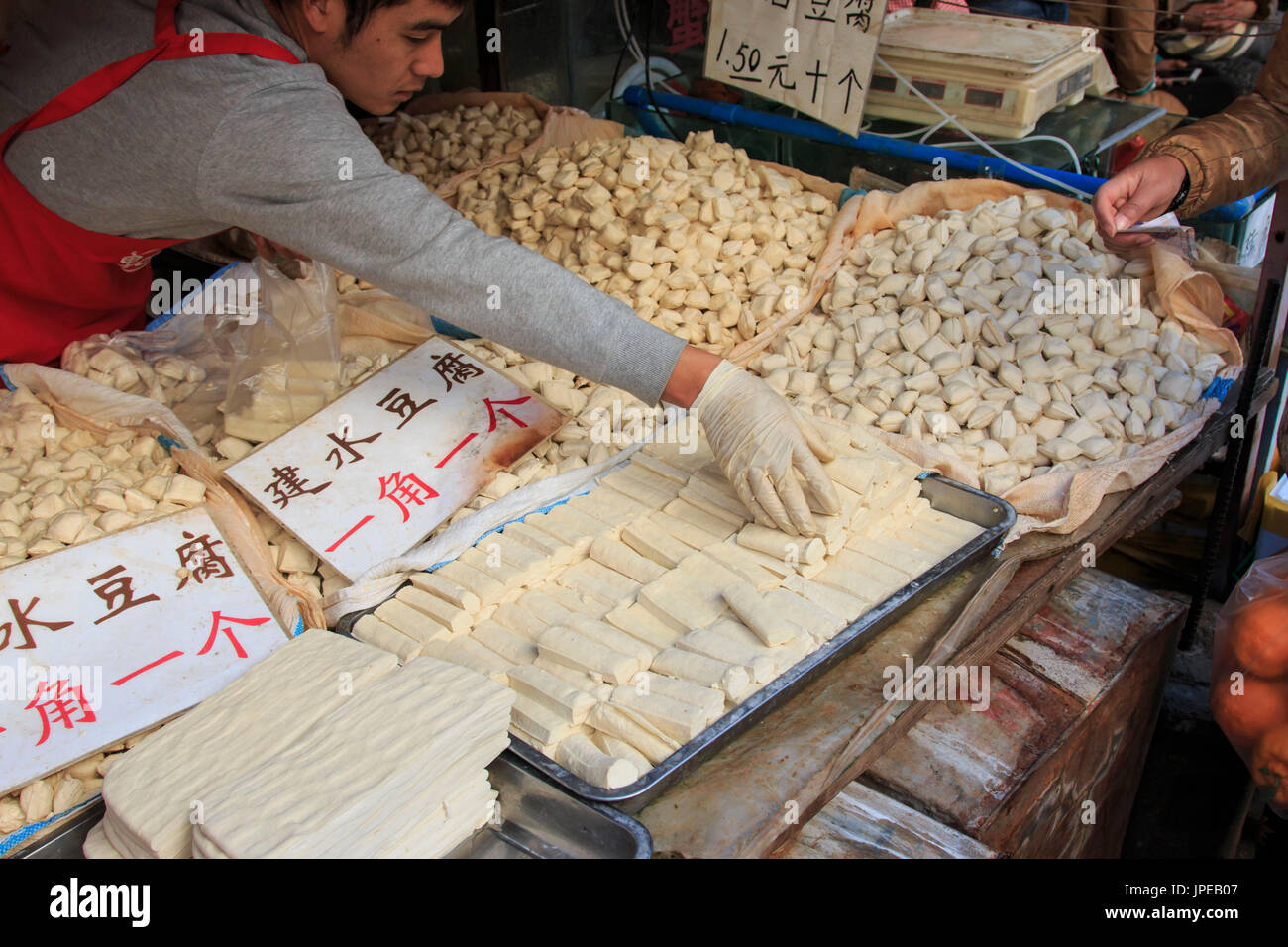 Man selling different varieties of tofu in market in kunming hi-res ...
