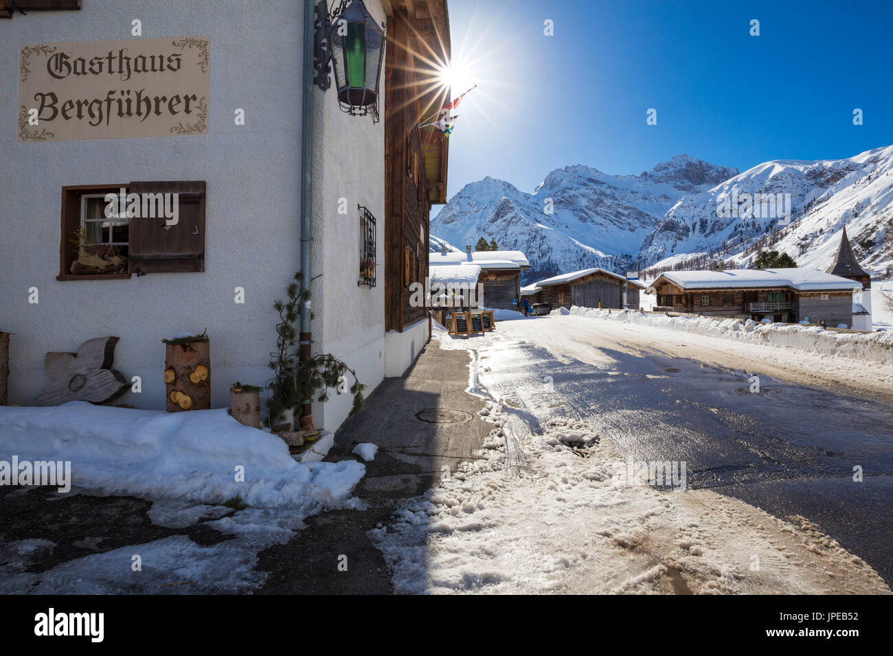 Main street of Sertig Dorfli illuminated by the sun. Sertigtal ...