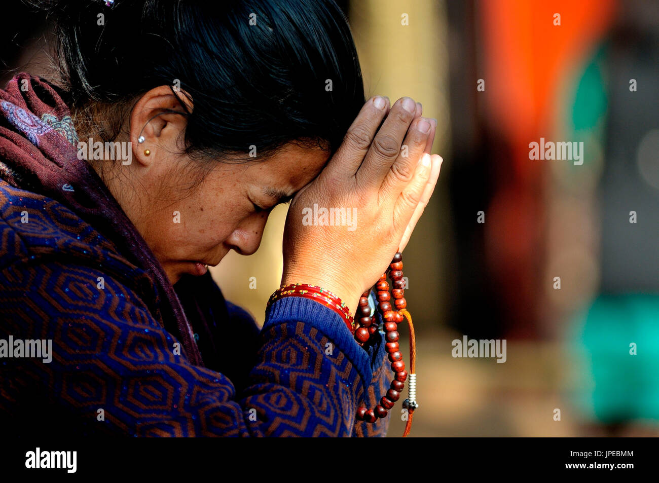A woman prays with deep faith at the time of Swayambhunath in Kathmandu ...