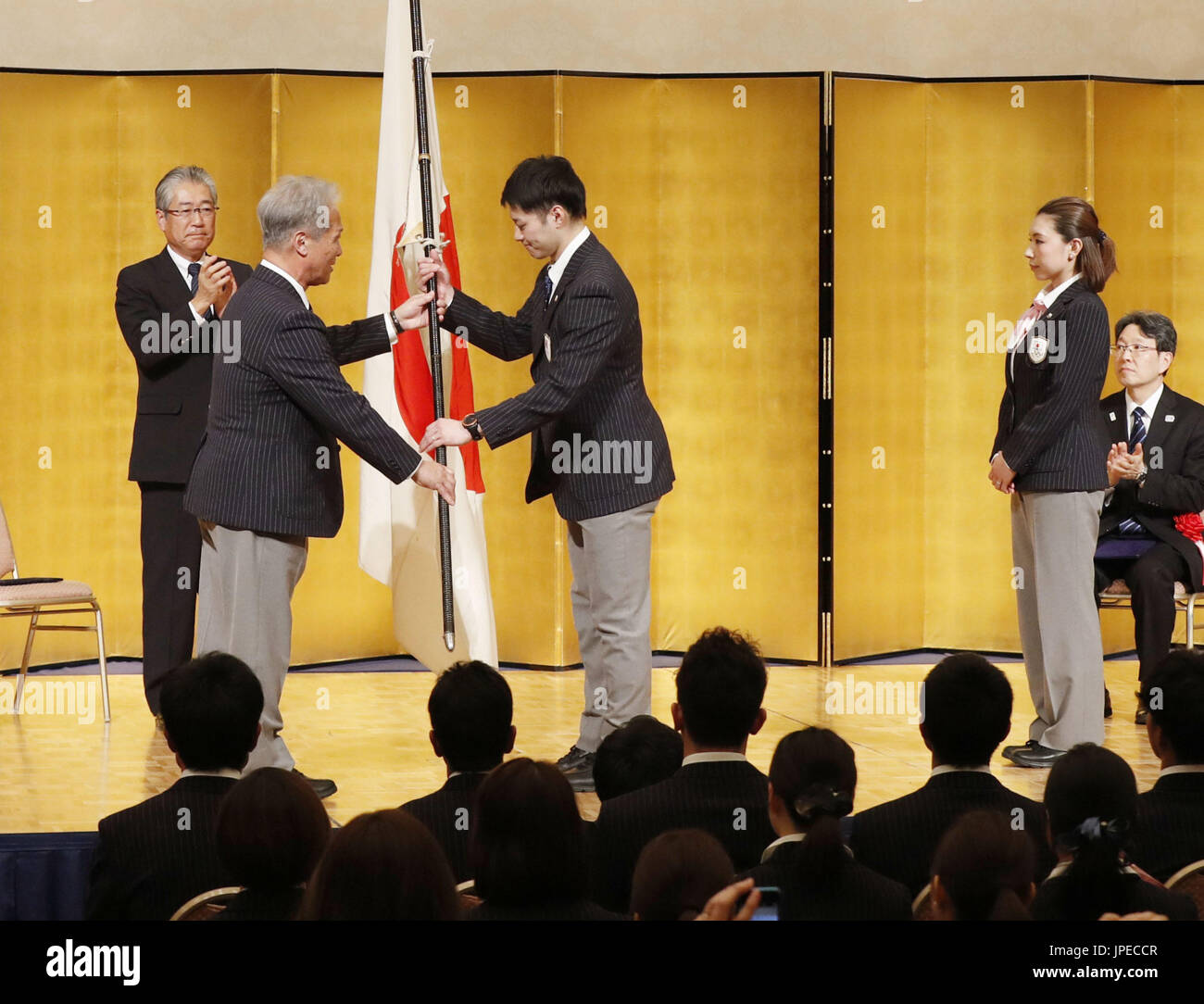 Go Tanaka, captain of the Japanese men's ice hockey team, receives the ...