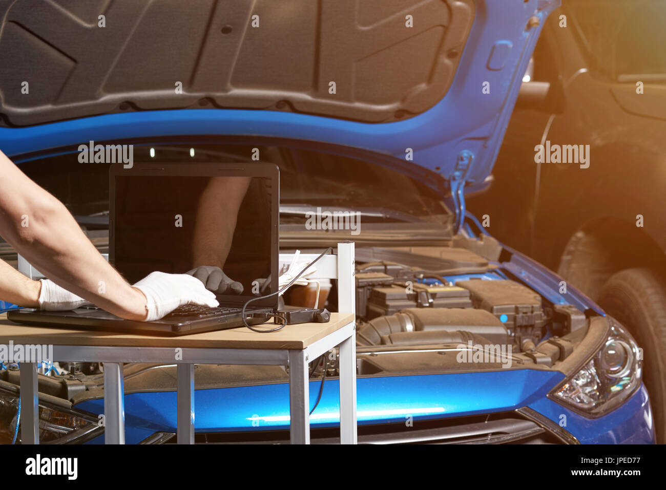Mechanic checking modern car with laptop computer diagnostic. Auto ...
