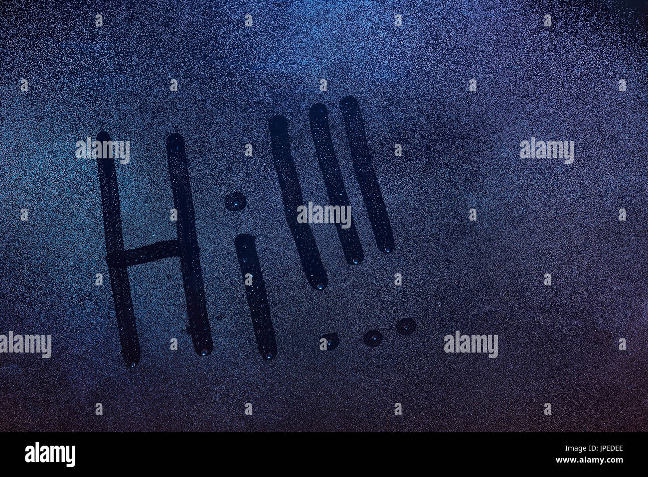 Hi message on glass of window in winter time. Hi word draw on wet glass ...