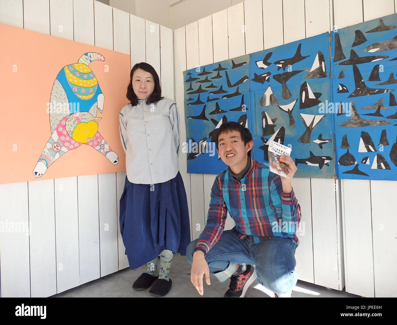 Artists Michiko Matsumoto (L) and Taro Ito pose in front of their respective works at the Studio ...