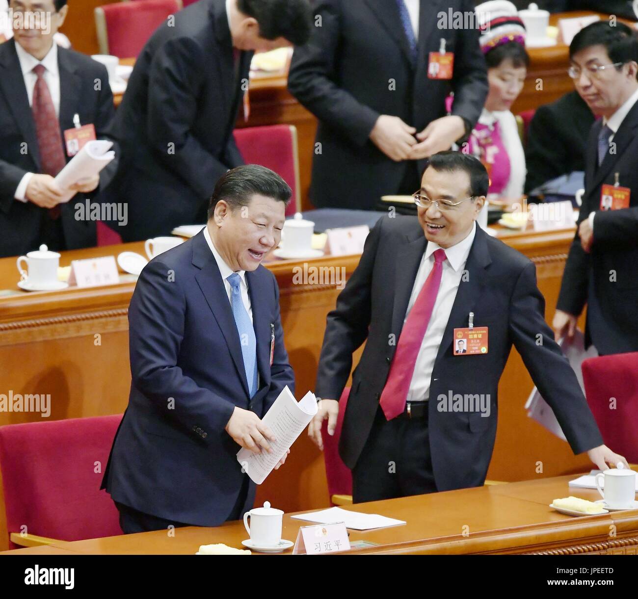 Chinese President Xi Jinping (L) and Premier Li Keqiang smile following ...