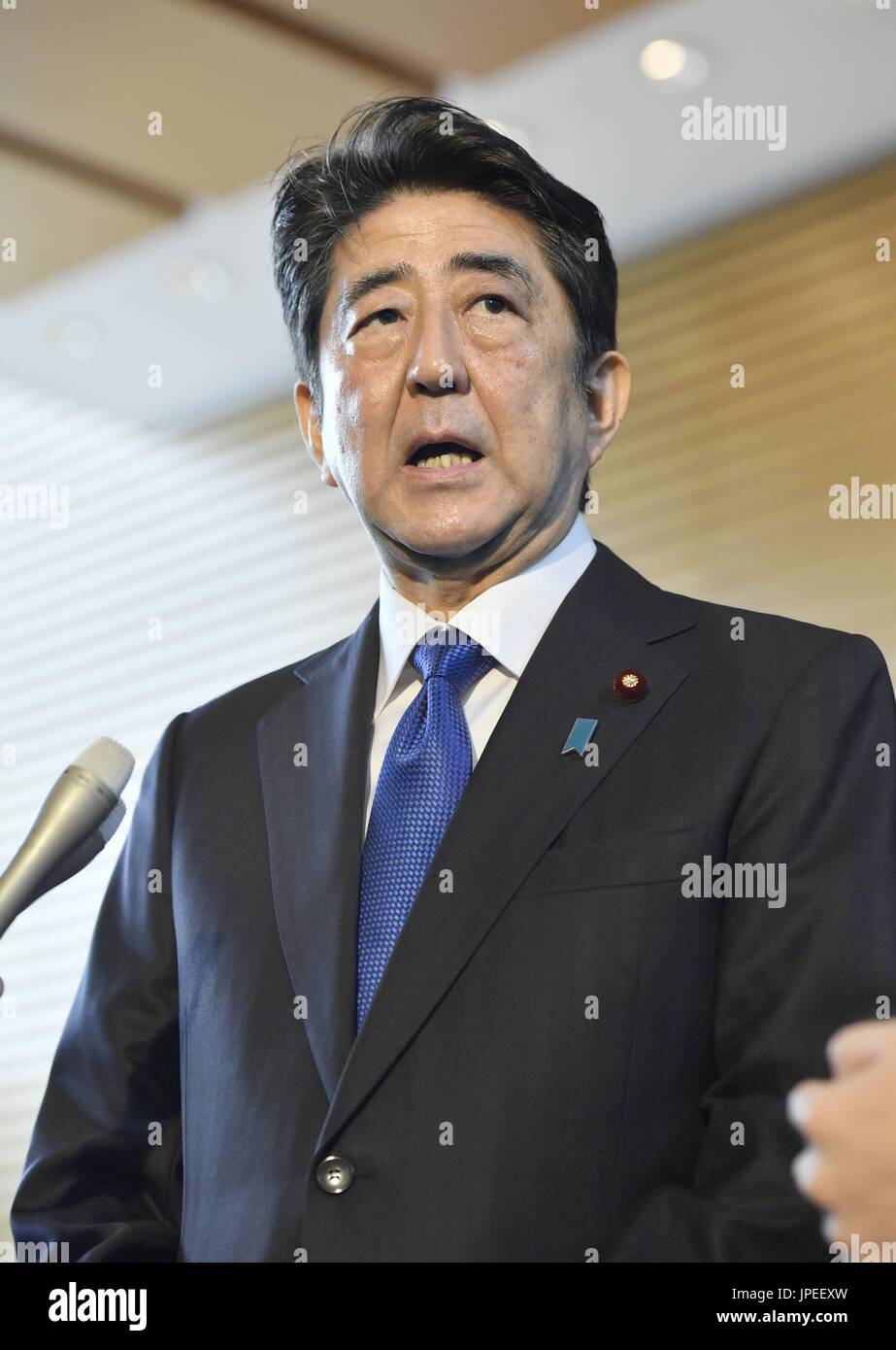 Japanese Prime Minister Shinzo Abe speaks with reporters at his office ...